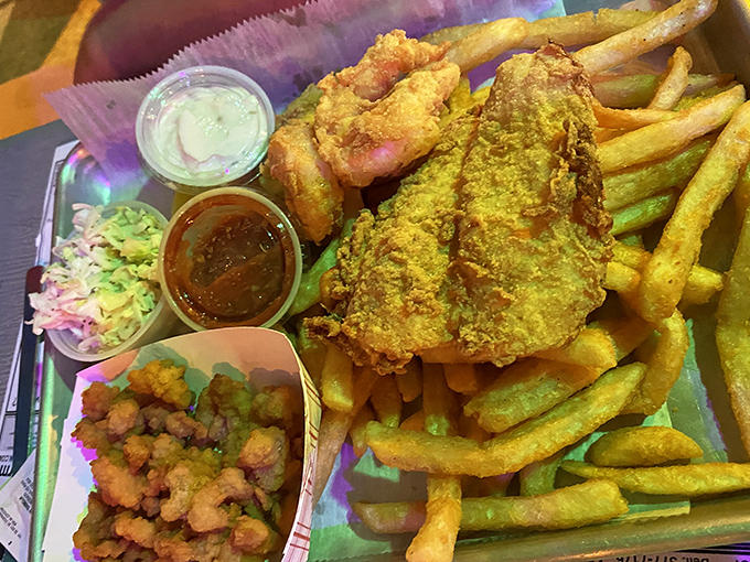 Fresh seafood gets the royal treatment here, served alongside crispy fries and colorful sides that complete the coastal experience.