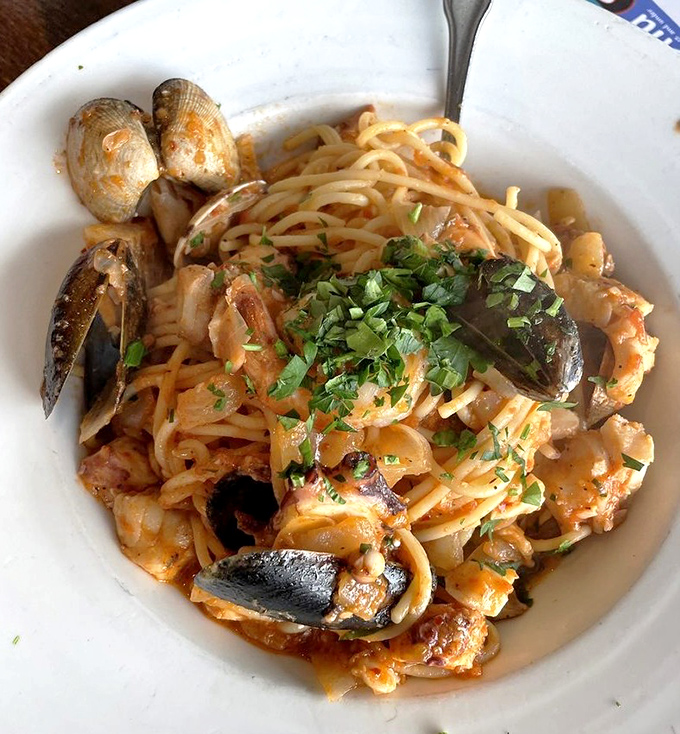 Seafood spaghetti that looks like the ocean and pasta had a beautiful love affair, with herbs playing matchmaker.