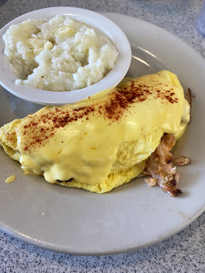 This isn't just an omelet; it's a yellow canvas painted with cheese and filled with treasures from the sea. Paired with grits? Pure Southern poetry.