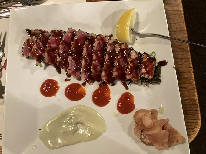 Seared ahi tuna that walks the perfect line between raw and cooked—like a culinary high-wire act that lands with delicious precision.