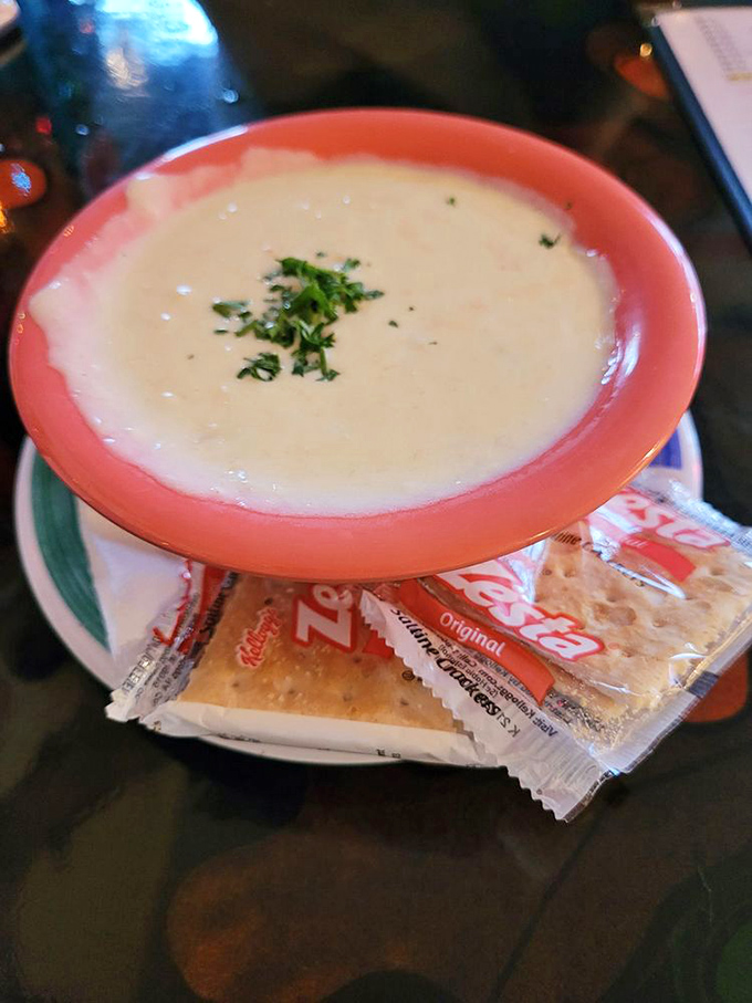 The legendary she crab soup arrives like a creamy cloud in a coral bowl. That sprinkle of green herbs isn't decoration&mdash;it's an invitation.