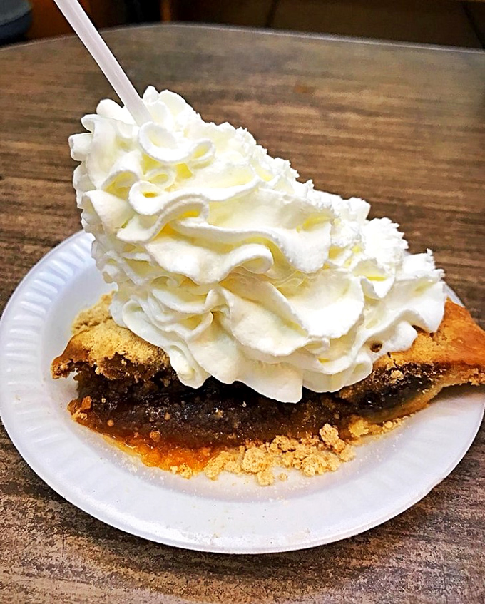 A slice of shoo-fly pie crowned with a mountain of whipped cream &ndash; because sometimes more is exactly the right amount.