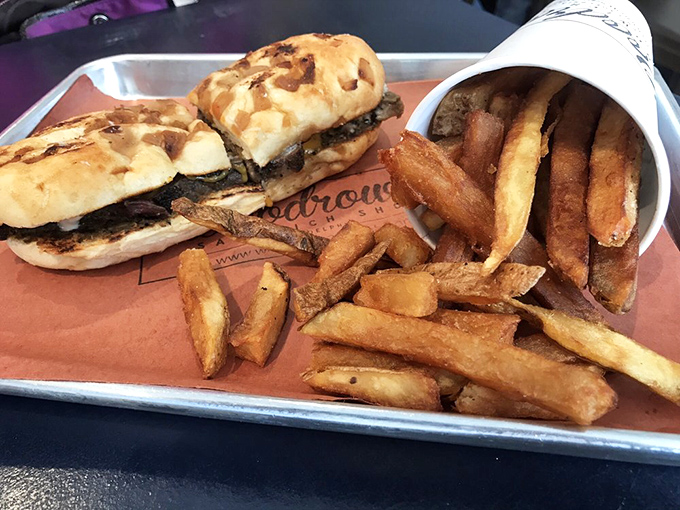 A sandwich that demands to be photographed, then immediately devoured. Crispy sweet potato straws crown tender meat like an edible tiara.