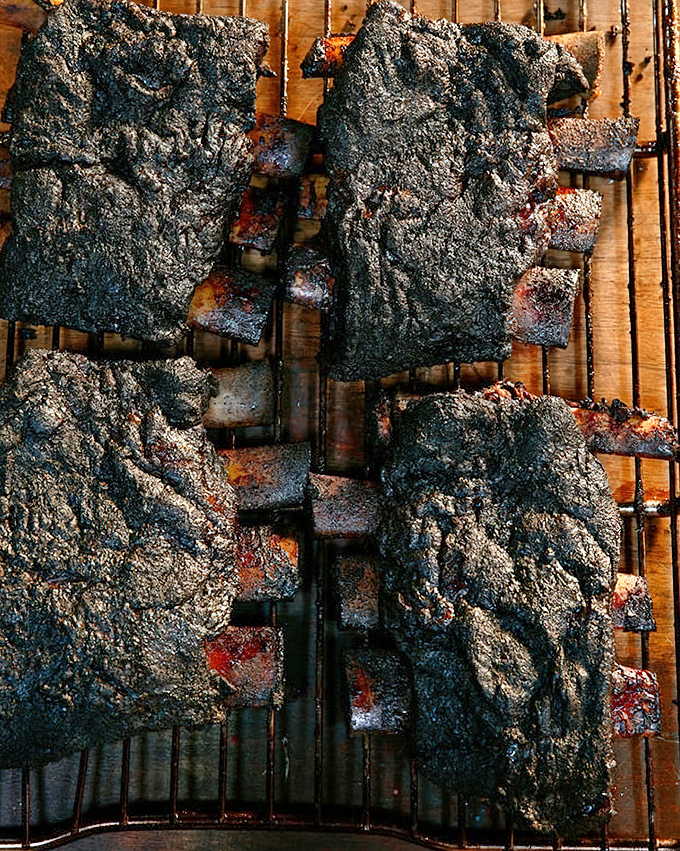 These ribs haven't just been smoked, they've been transformed – the blackened bark protecting meat so tender it practically surrenders to your gaze.