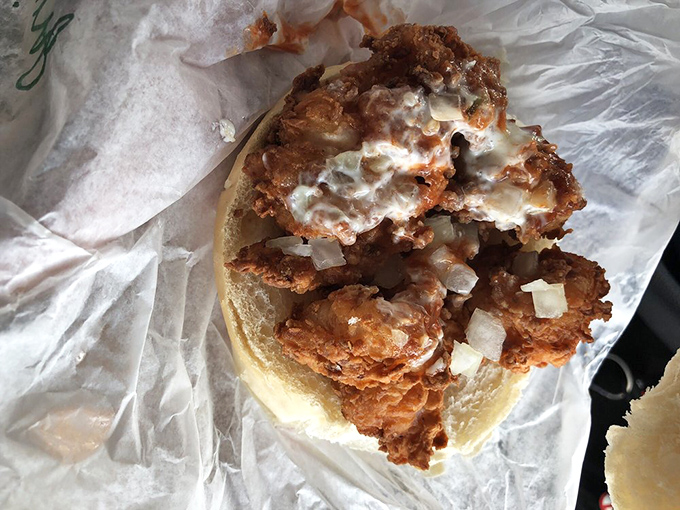Fried shrimp sandwich that looks like it's trying to escape its bread prison. Don't worry &ndash; your stomach is a much nicer place to end up.