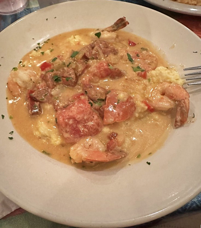 Shrimp and grits swimming in a savory sauce &ndash; Southern comfort meets Florida seafood in perfect harmony.