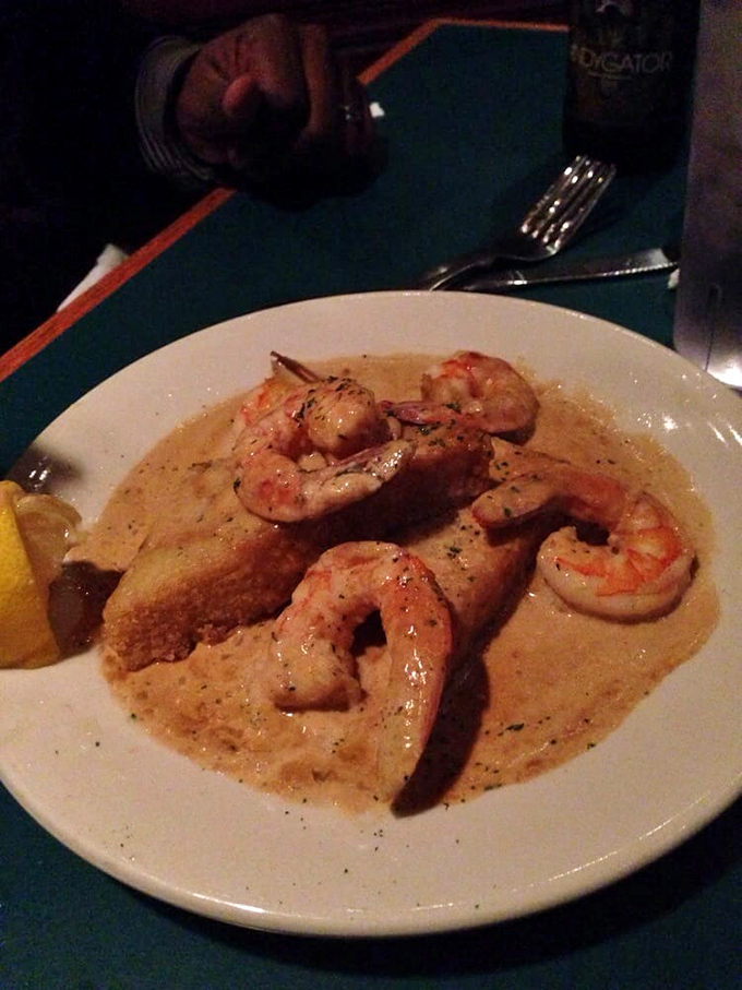 Shrimp swimming in creamy sauce with a slice of bread for sopping&mdash;because letting any of that liquid gold go to waste would be a culinary crime.