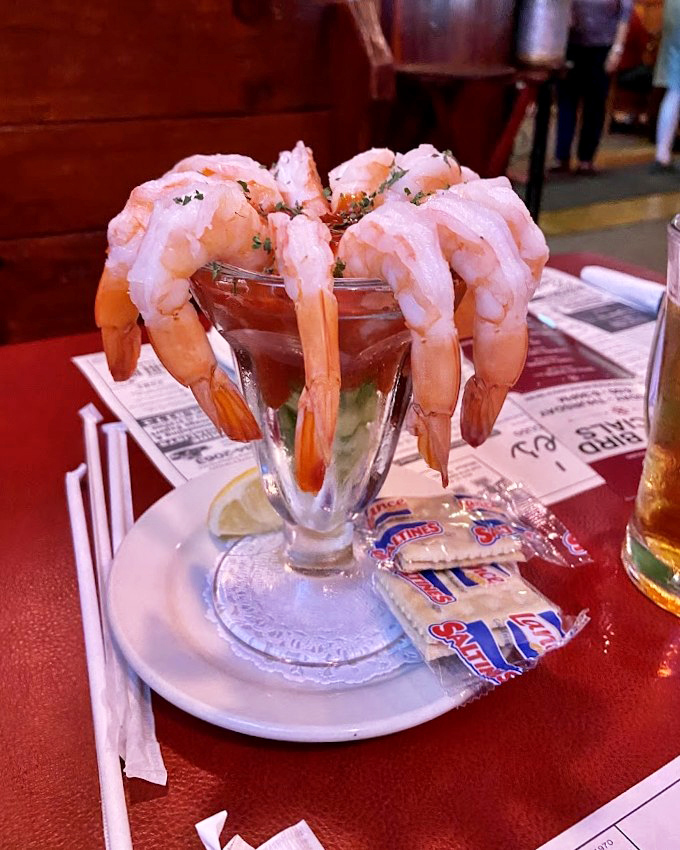 The shrimp cocktail &ndash; where each plump crustacean hangs off the glass like it's showing off. Ocean-fresh flavor that makes you forget you're in landlocked Ohio.