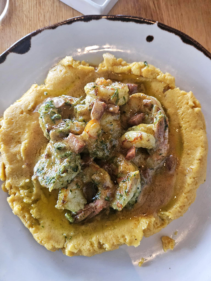 Shrimp and grits elevated to an art form. The yellow cornmeal canvas supports plump shrimp performers in a delicious culinary theater.