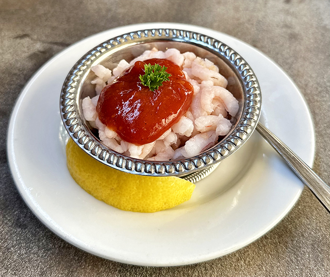 The shrimp cocktail arrives like tiny treasures in a silver chalice. A refreshing prelude to the meat marathon ahead.