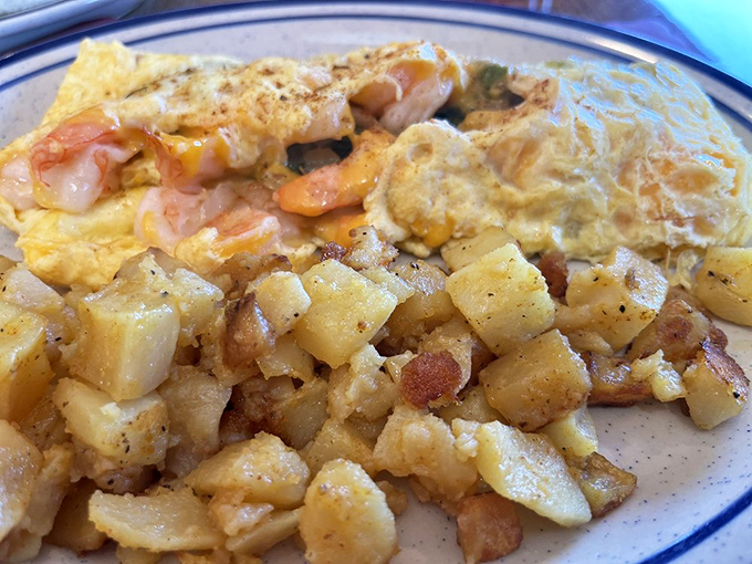 A fluffy shrimp-studded omelet alongside home fries that look like they've achieved the holy grail: crispy outside, tender inside.