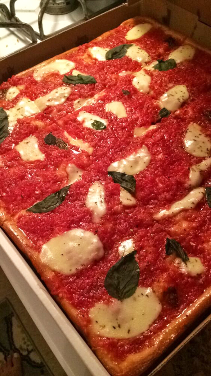 Sicilian-style pizza that's a love letter to Italy. Those pools of fresh mozzarella and basil leaves are practically singing "That's Amore."