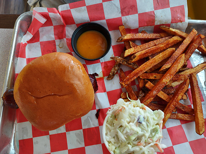 A sandwich that requires both hands and a strategy&mdash;crispy fries, creamy slaw, and a bun that somehow contains the smoky avalanche within.