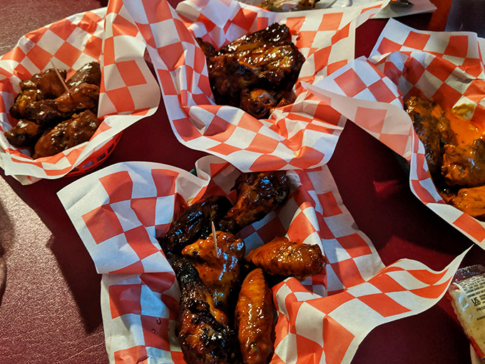 Wings nestled in checkered paper boats, glistening with sauce and promise. These aren't just appetizers&mdash;they're the opening act to a barbecue symphony.