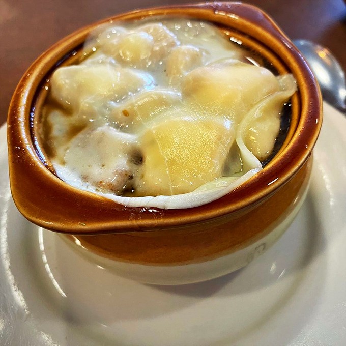 French onion soup that doesn't just warm your body but hugs your soul &ndash; a steaming crock of brothy bliss topped with melty cheese islands.