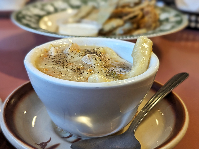 A steaming cup of homemade soup that looks like it could cure everything from a cold to a bad day at the office.