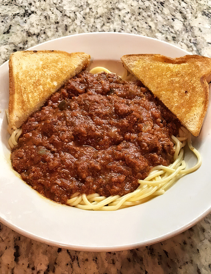 Spaghetti with meat sauce and Texas toast&mdash;proof that sometimes the simplest pleasures don't need fancy names or truffle oil to change your day.