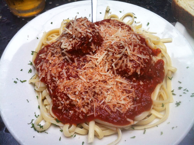 Spaghetti that doesn't just sit on the plate but commands it, with a crown of cheese that melts into the homemade sauce below.