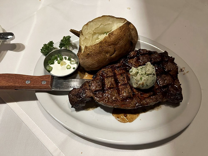 A baked potato the size of your fist, compound butter melting into a perfectly charred steak&mdash;this is happiness on a plate.