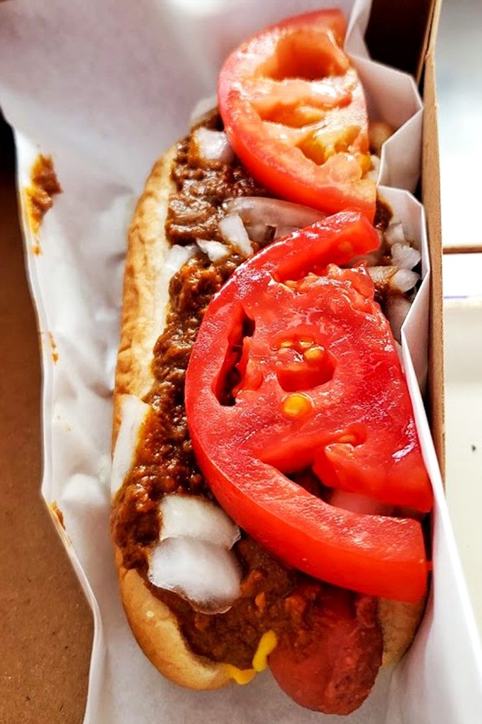 The chili dog at Carney's doesn't whisper, it announces itself with authority. Those fresh tomato slices add a bright note to the symphony of savory flavors.