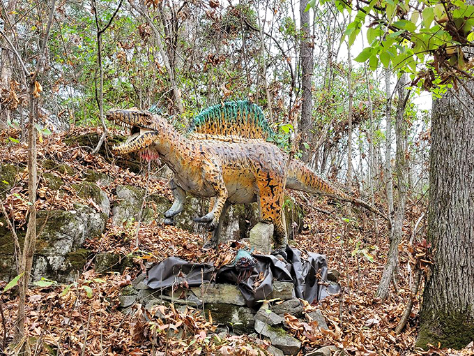 A fearsome Spinosaurus model emerges from autumn foliage, its distinctive sail and elongated snout capturing the essence of this river-dwelling predator.