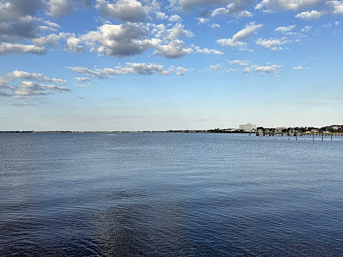 The St. Lucie River stretches toward the horizon like nature's welcome mat, offering the kind of serenity that makes blood pressure medications unnecessary.