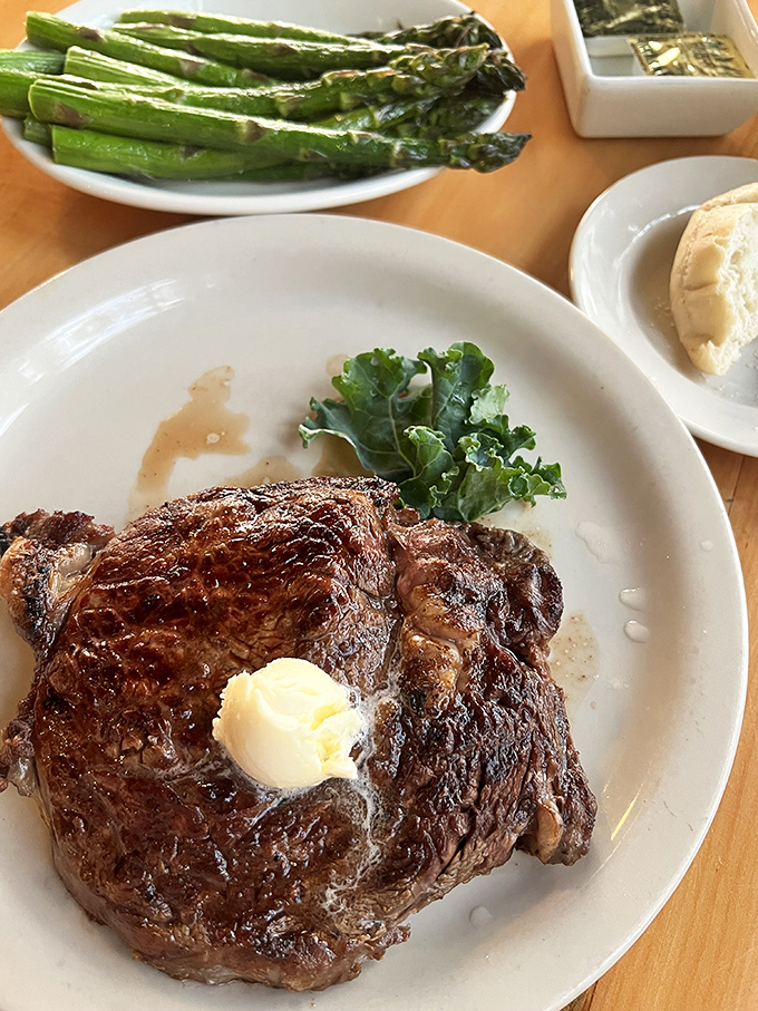 This ribeye, glistening with its own juices and topped with a melting pat of butter, is the carnivore's equivalent of finding buried treasure.