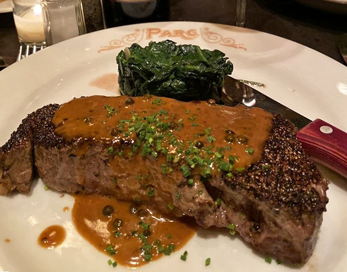 The steak au poivre isn't just dinner; it's a masterclass in the marriage of peppercorns, beef, and that silky sauce that dreams are made of.