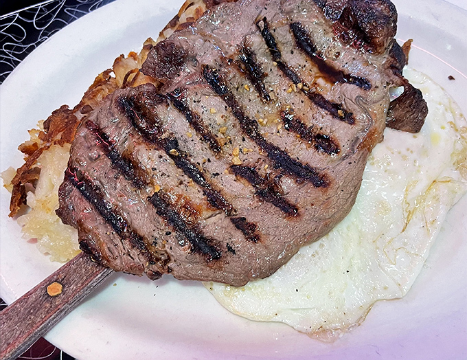 This steak isn't just cooked&mdash;it's respected. Perfectly grilled beef alongside sunny-side-up eggs that look like they're smiling at you.