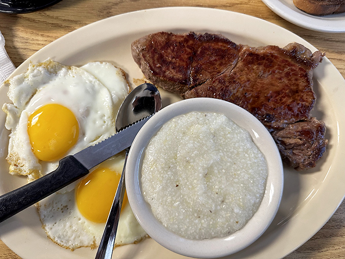 Steak and eggs&mdash;the breakfast of champions or the lunch of geniuses? Either way, that sunny-side up perfection alongside grits is pure Midwest poetry.