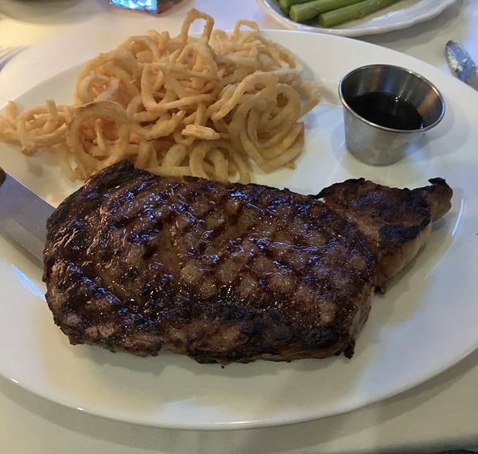 A properly cooked steak with a mountain of those famous onion strings&mdash;a combination that should be prescribed by doctors.