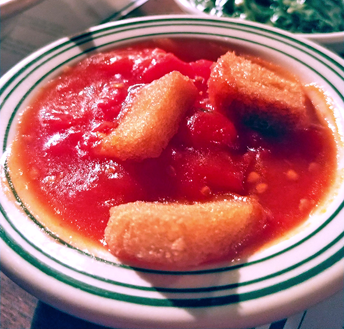 Stewed tomatoes that would make your grandmother both jealous and proud. Those bread chunks soaking up that savory-sweet goodness? Pure genius.