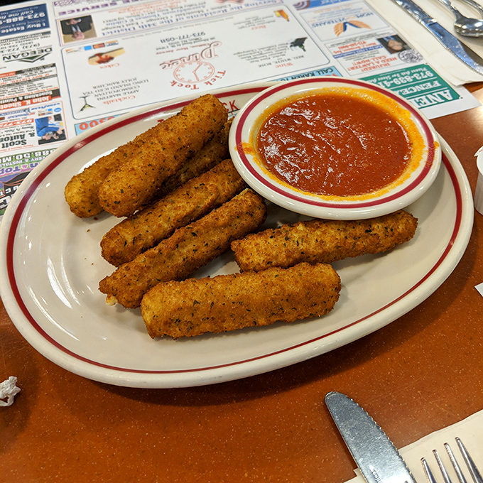 Mozzarella sticks: the diplomatic negotiators between your hunger and your patience, crispy on the outside, stretchy on the inside, with marinara as the mediator.