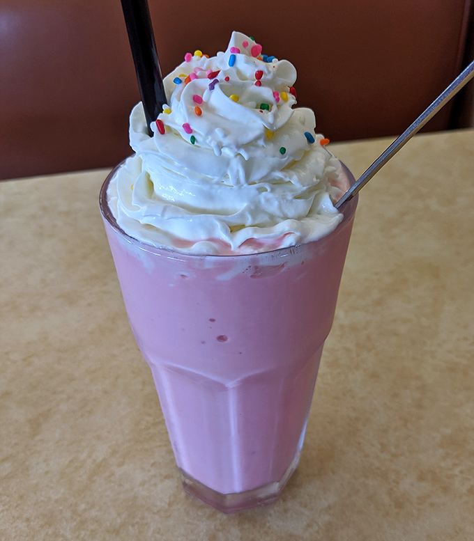 This strawberry milkshake isn't playing games &ndash; it's thick enough to require a spoon first, with sprinkles that remind you it's okay to feel like a kid again.
