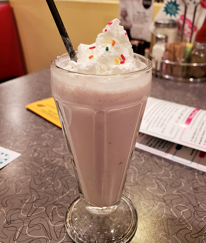 This isn't just a strawberry shake&mdash;it's summer vacation in a glass, complete with whipped cream mountain and sprinkle confetti.