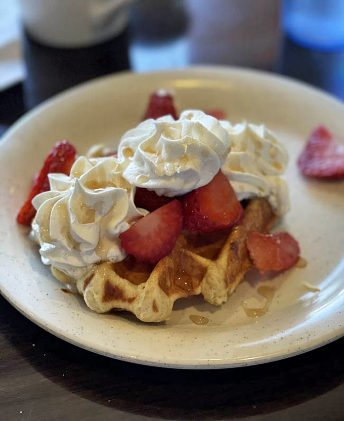 Waffle perfection exists, and it comes topped with fresh strawberries and clouds of whipped cream that melt into those golden squares.