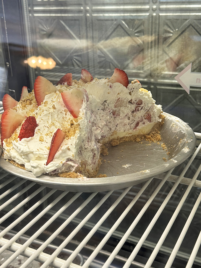 This strawberry cream pie isn't just dessert; it's a fluffy cloud of sweetness that would make even the most disciplined dieter throw caution to the wind.