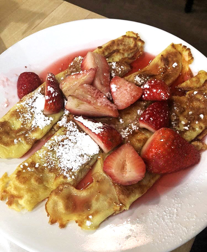 Crepes that would make a Parisian nod in approval. Fresh strawberries and a dusting of powdered sugar transform breakfast into an elegant affair.