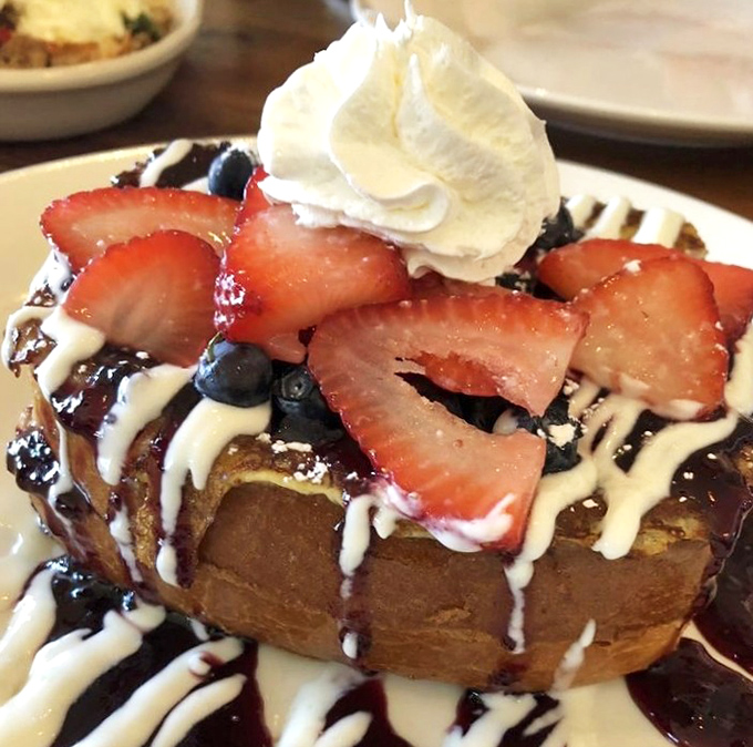 French toast elevated to art form – layers of brioche, berries, and cream that would make even French pastry chefs tip their berets in respect.
