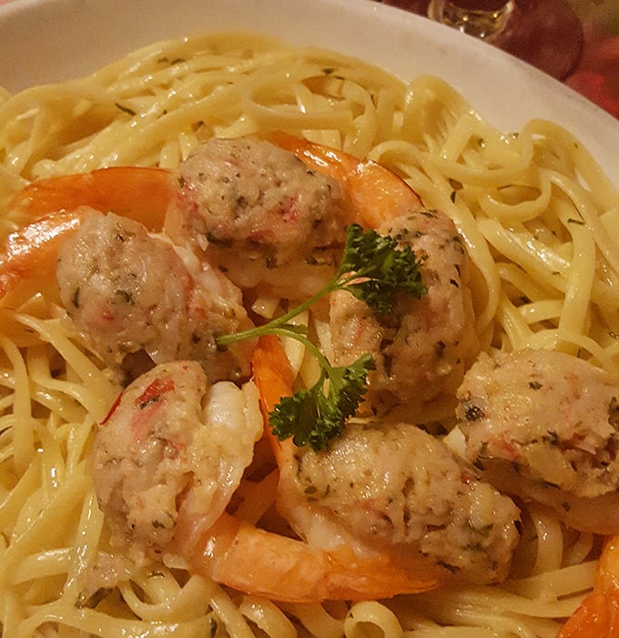 Plump stuffed shrimp lounging on a bed of linguini like they own the place. The garnish isn't just for show &ndash; it's saying "Yes, we care about the details."
