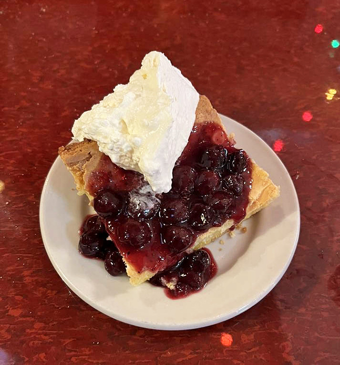 Berry pie that strikes the perfect balance between homestyle comfort and restaurant finesse. That whipped cream isn't just a topping&mdash;it's the crown jewel.