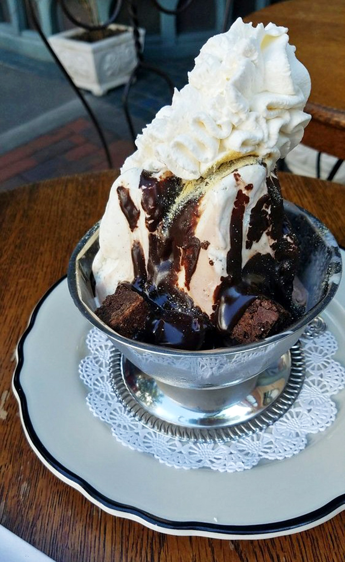Behold the Mt. Vesuvius in all its erupting glory! Hot fudge cascades down vanilla peaks while brownie chunks create the perfect textural landscape.