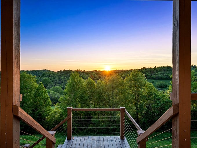 Tennessee sunsets hit differently when viewed from a cabin porch. This golden hour view showcases the rolling hills that cradle Lynchburg in natural splendor.
