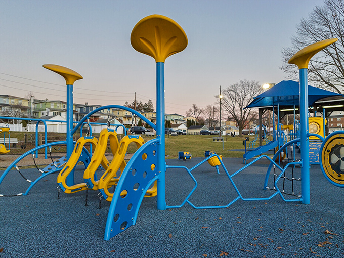 Blue and yellow playground equipment stands ready for tiny adventurers, proof that Conshohocken takes its fun as seriously as its history.