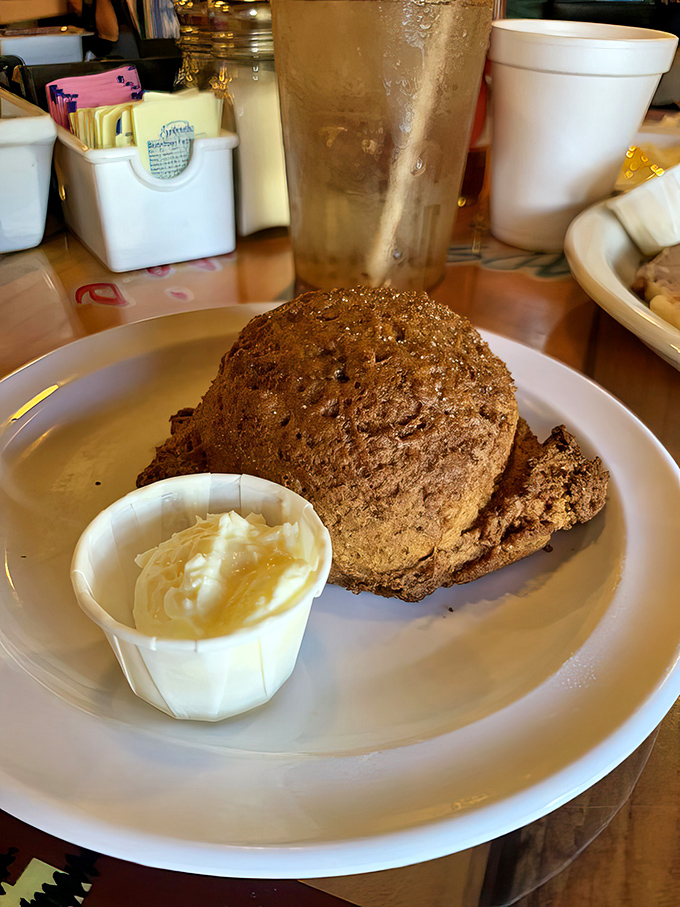 Sweet potato biscuits arrive like golden treasures, accompanied by honey butter that's basically edible sunshine in a cup.