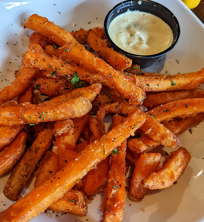 Sweet potato fries with herbs and dipping sauce&mdash;proof that vegetables can have fun too.