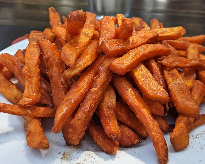 These aren't just sweet potato fries; they're golden-orange treasures dusted with Mediterranean spices that make regular fries seem like they're not even trying.