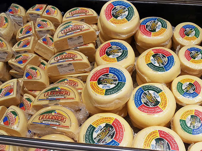 Wheels of Swiss cheese stacked like delicious vinyl records, each one ready to play a symphony of flavor on your taste buds.