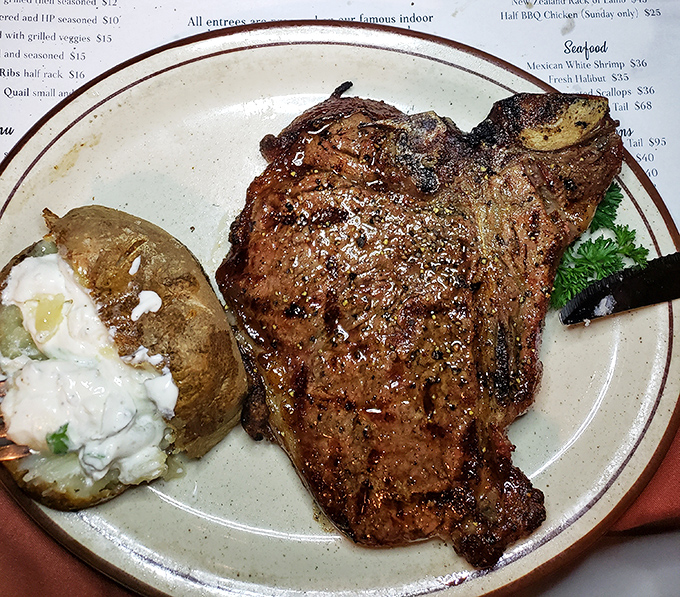 A steak so magnificent it deserves its own ZIP code. That loaded baked potato isn't just a side&mdash;it's a worthy companion on this flavor journey.