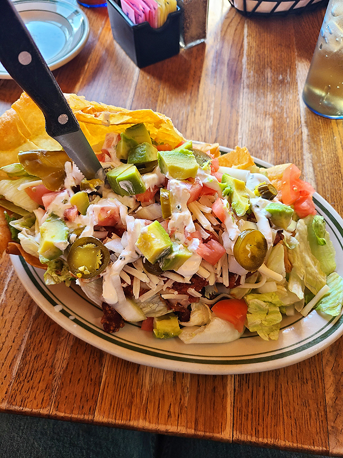 The legendary taco salad in all its glory. A crispy tortilla bowl cradles layers of flavor that locals drive miles to experience&mdash;worth every bite and napkin.